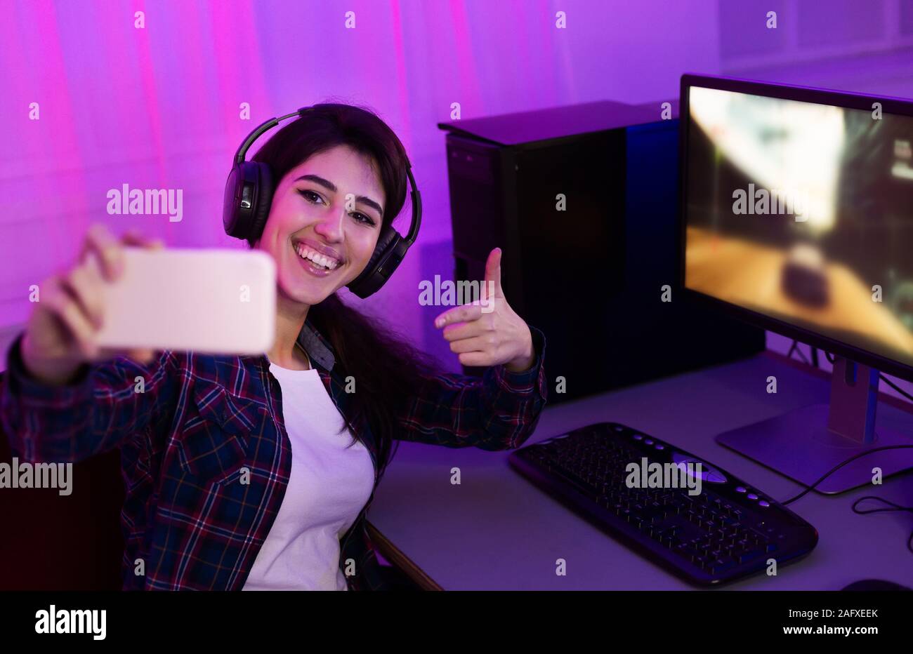 Excited gamer streamer girl taking selfie near pc computer Stock Photo ...