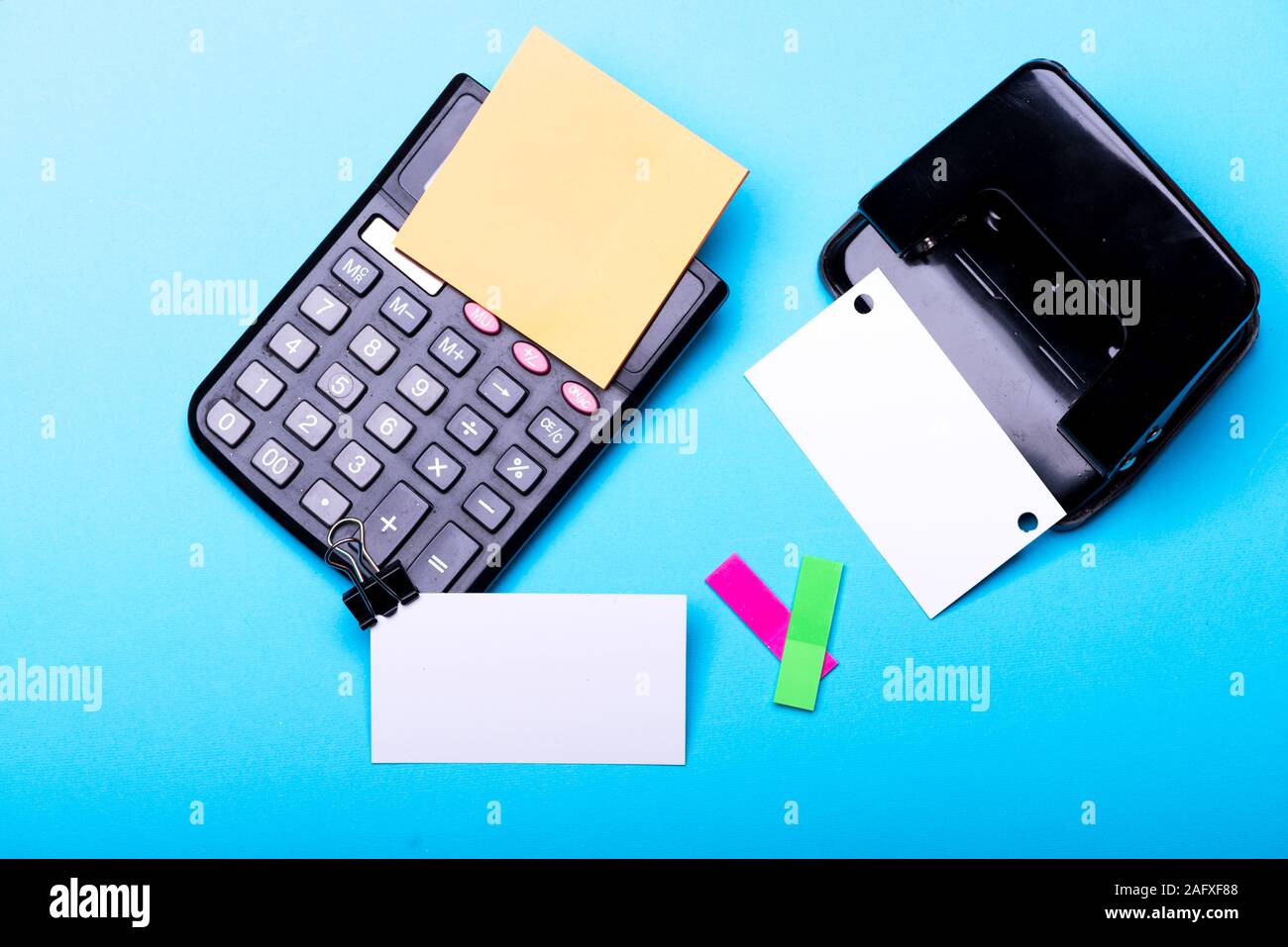 Stationery and calculator. Bookmarks of different colors near hole ...