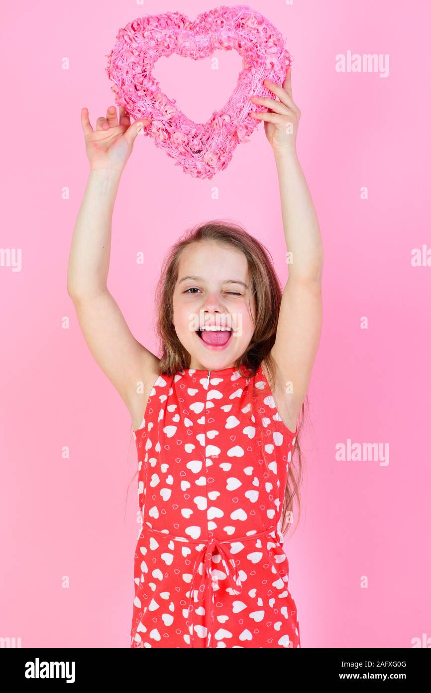 Valentines day, holiday celebration. Kid wink eye with raised hands on ...
