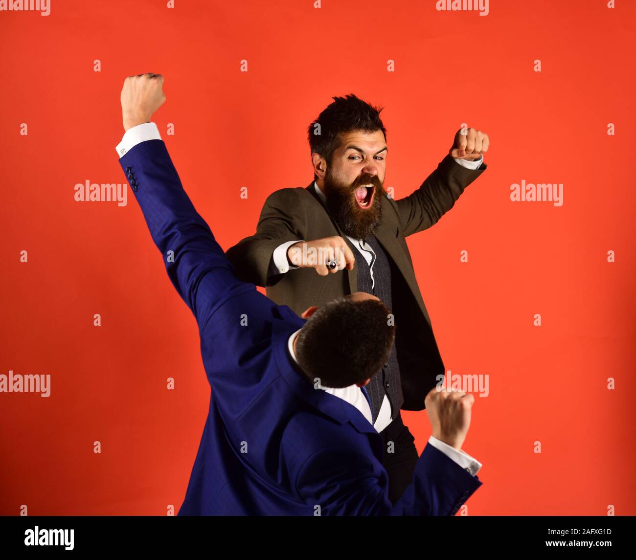 Businessman with mad face hits and punches opponent. Business rivalry ...