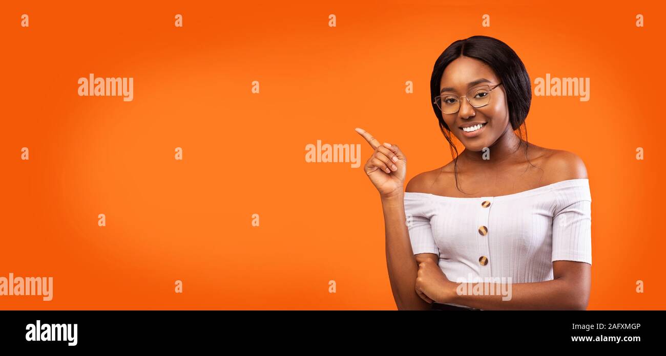 Afro Lady Pointing Finger Smiling Standing Over Orange Background ...
