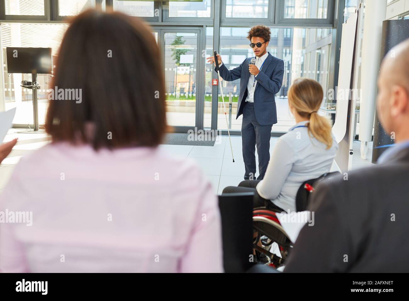 Blind businessman as a speaker at a congress or business meeting Stock ...