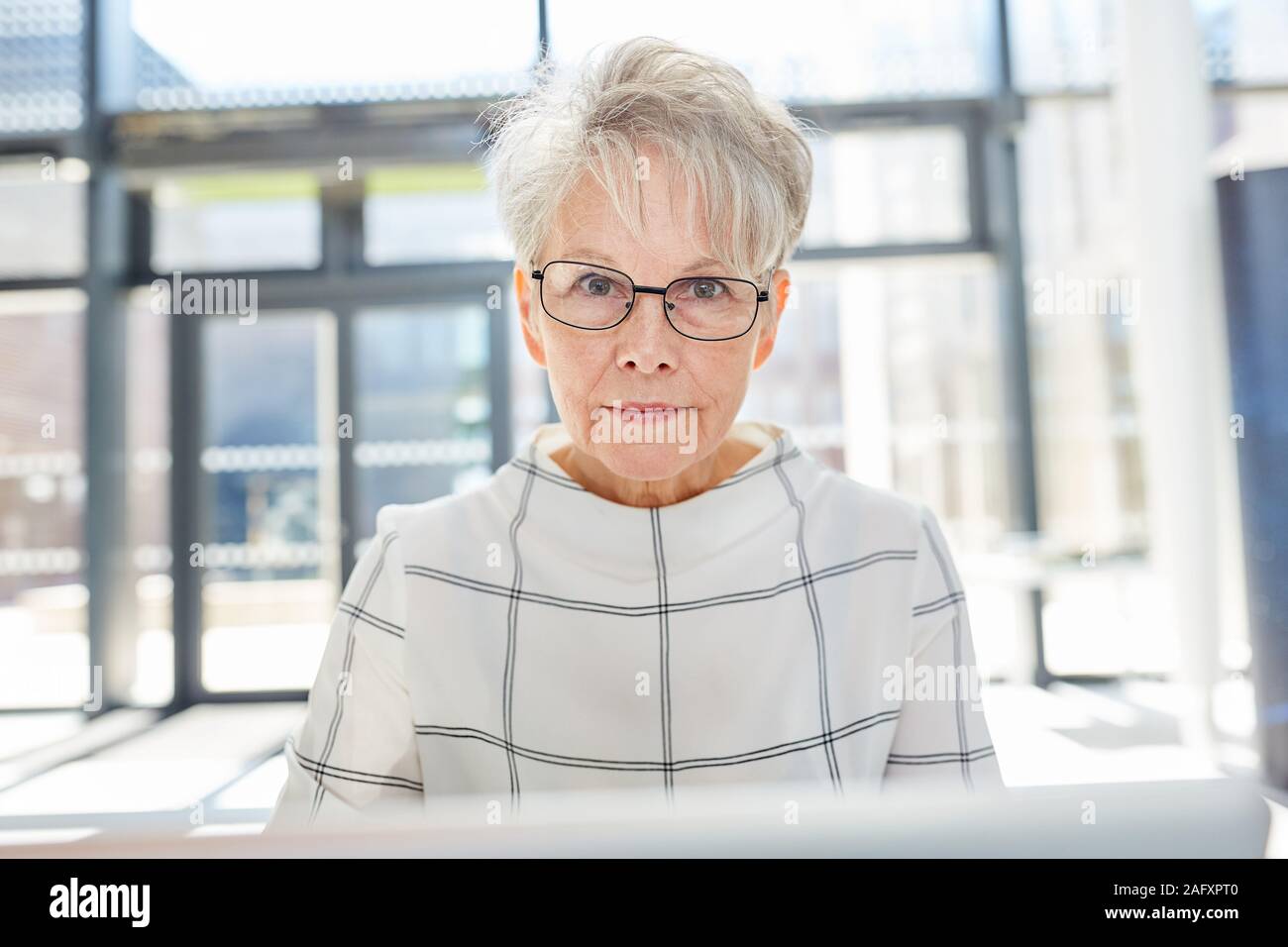 Elderly woman as a successful businesswoman with experience in the ...