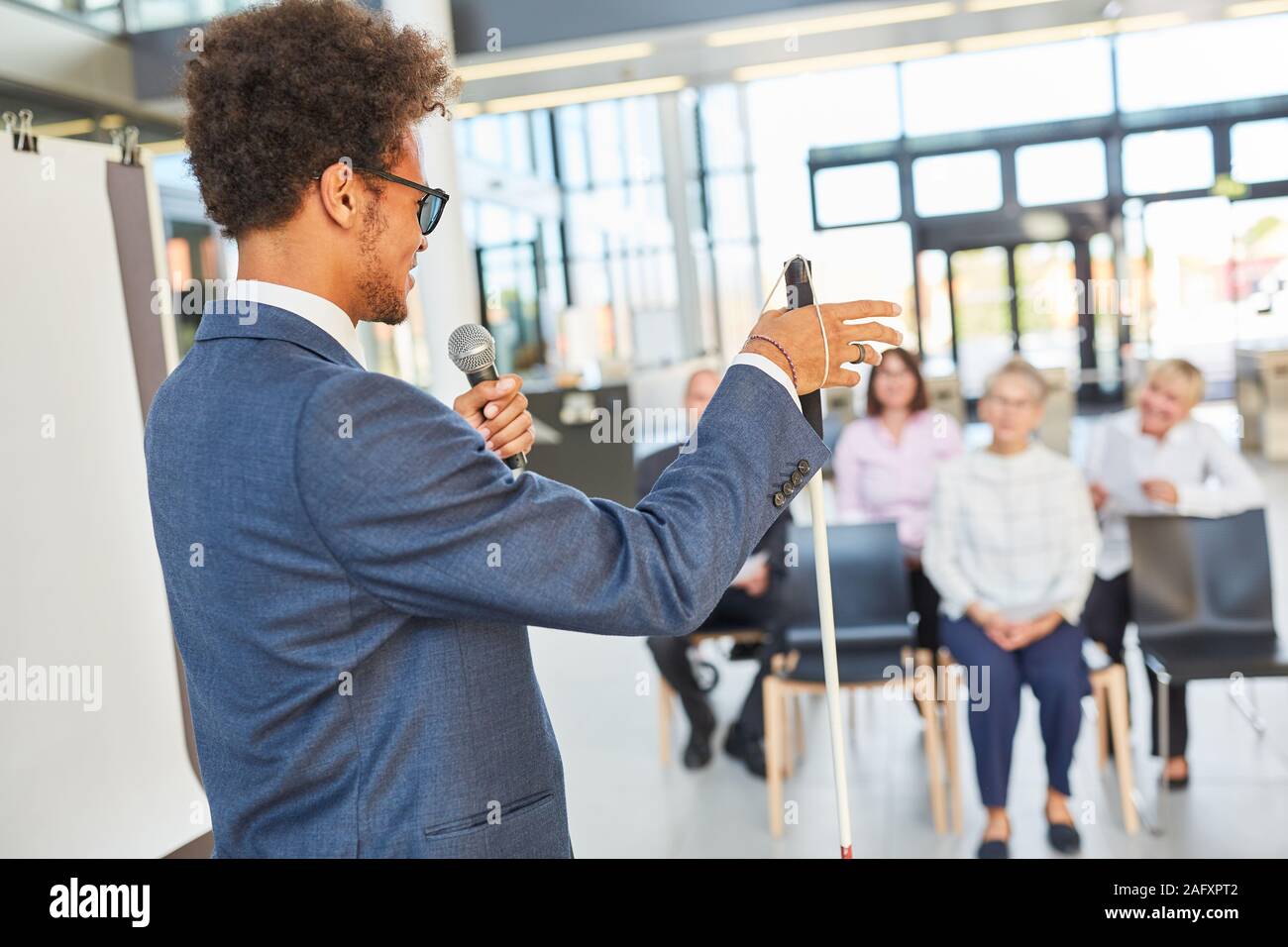 Blind business man as a speaker or life coach at a conference or ...