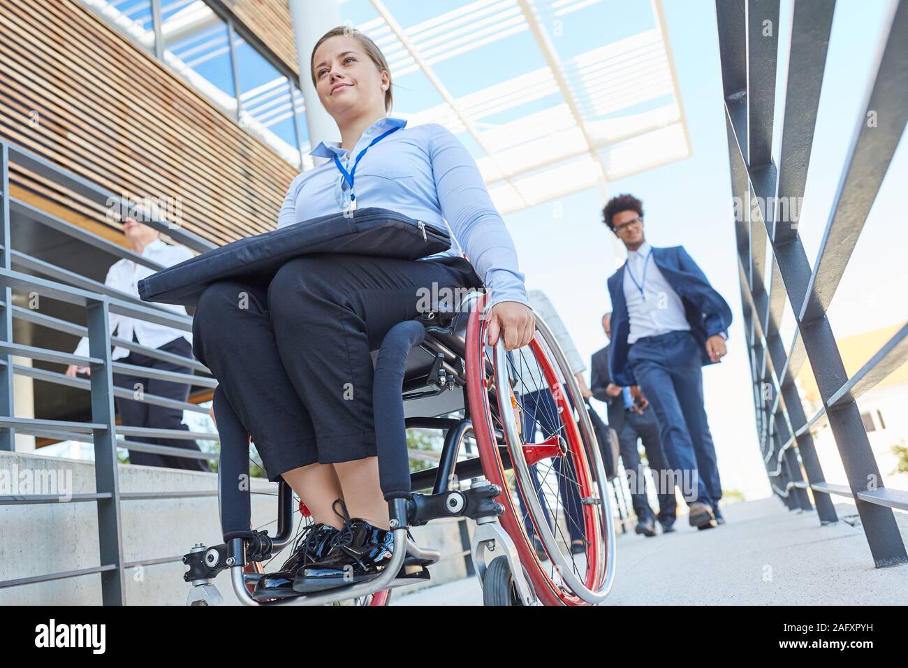 Disabled woman as a wheelchair user on a ramp for inclusion and ...