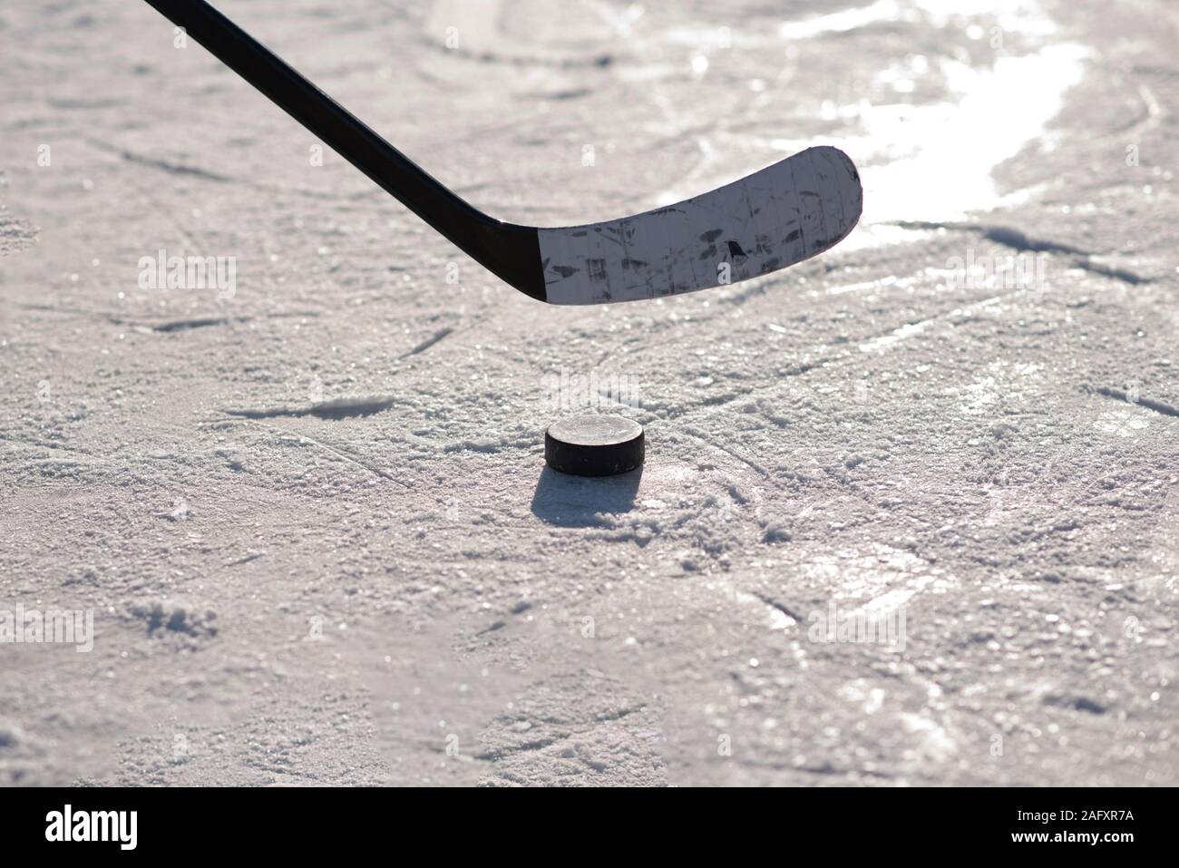 close-up stick and puck on the ice background Stock Photo - Alamy