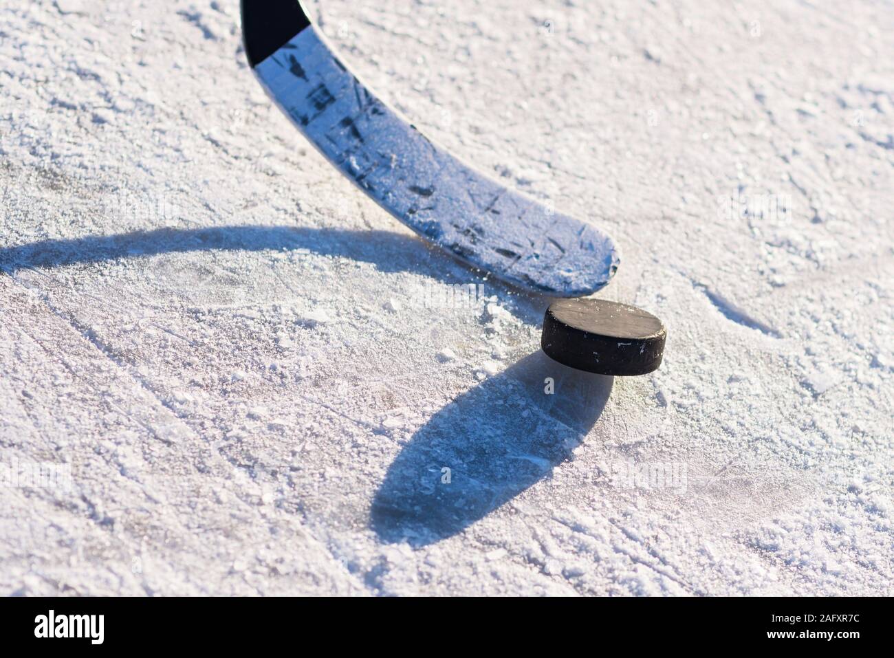close-up stick and puck on the ice background Stock Photo - Alamy