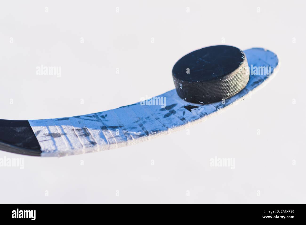 close-up stick and puck on the ice background Stock Photo - Alamy