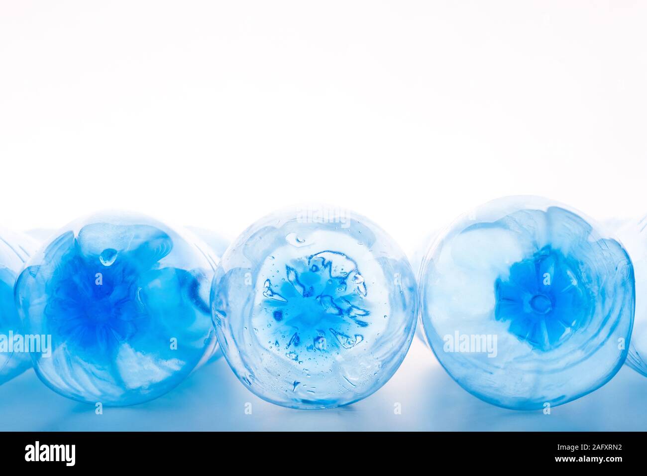Top view of plastic bottles bottoms on white background Stock Photo - Alamy