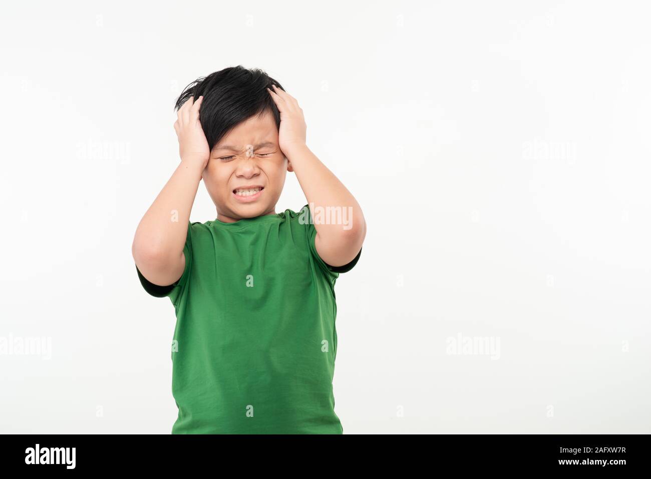 Cute boy suffering from headache on white background Stock Photo - Alamy