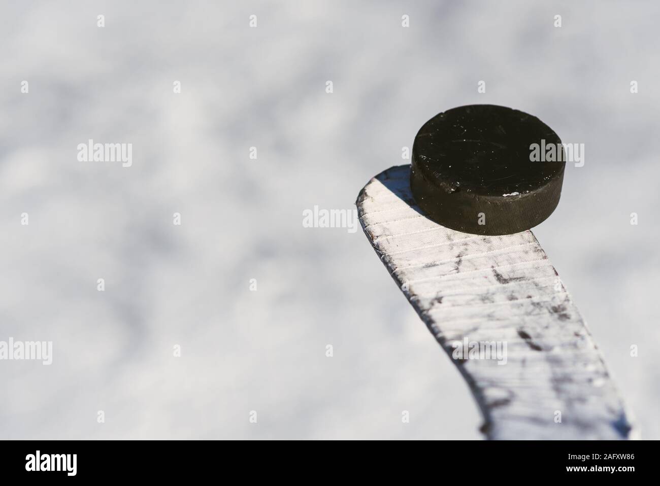 close-up stick and puck on the ice background Stock Photo - Alamy