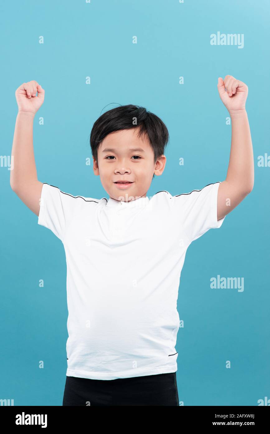 Cute asian boy smiles with raised arms Stock Photo - Alamy