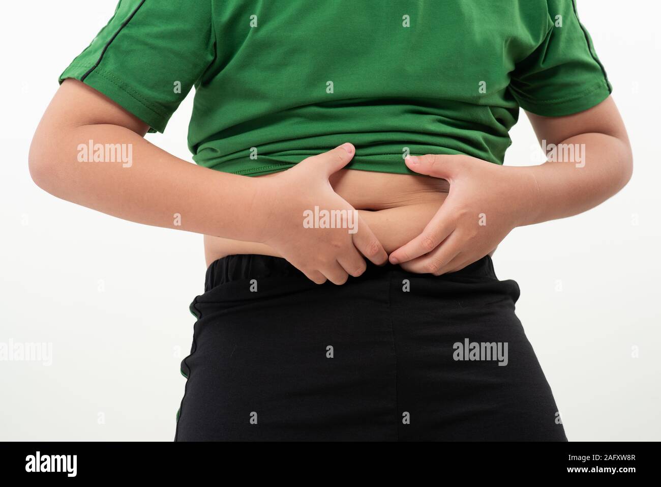 Asian little boy with stomach ache, child holding his hands on his ...