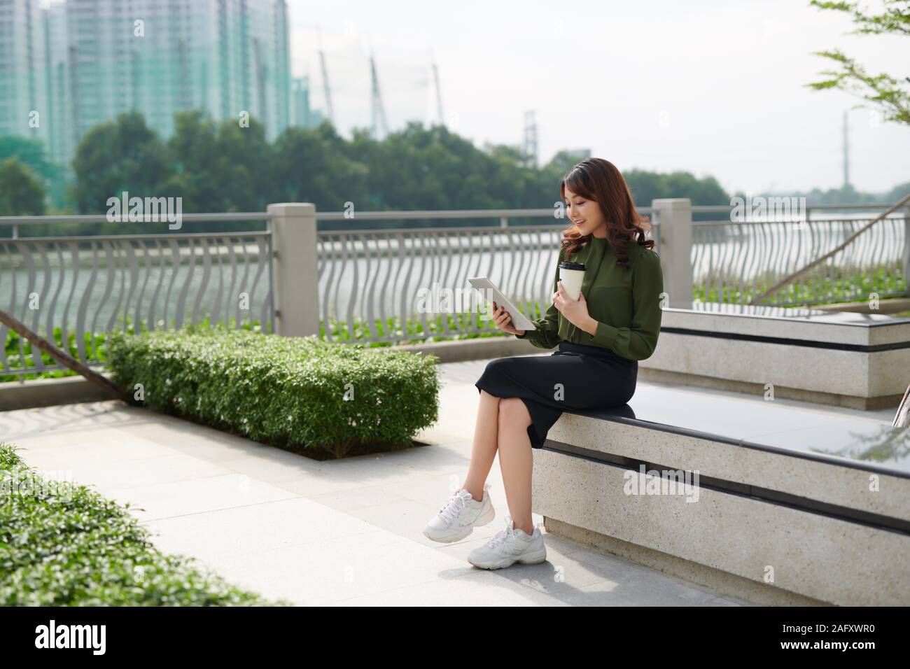 Asian lady sitting on bench hi-res stock photography and images - Alamy