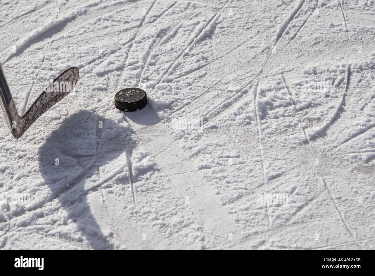 close-up stick and puck on the ice background Stock Photo - Alamy
