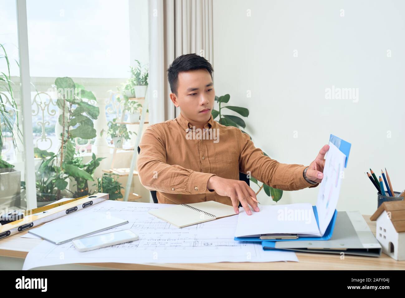 Handsome architect sitting table hi-res stock photography and images ...