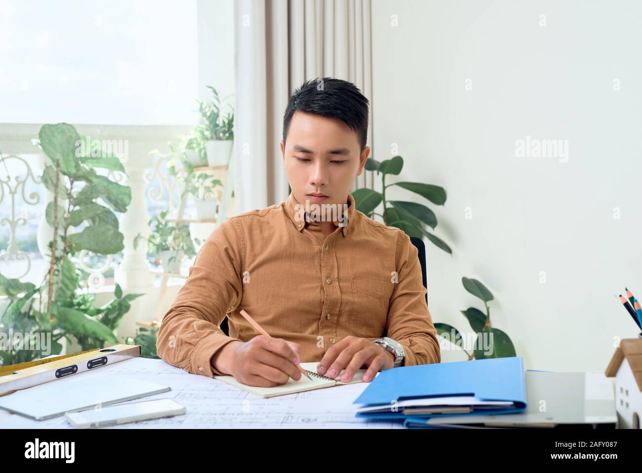Portrait of young Asian architect man working at office Stock Photo - Alamy
