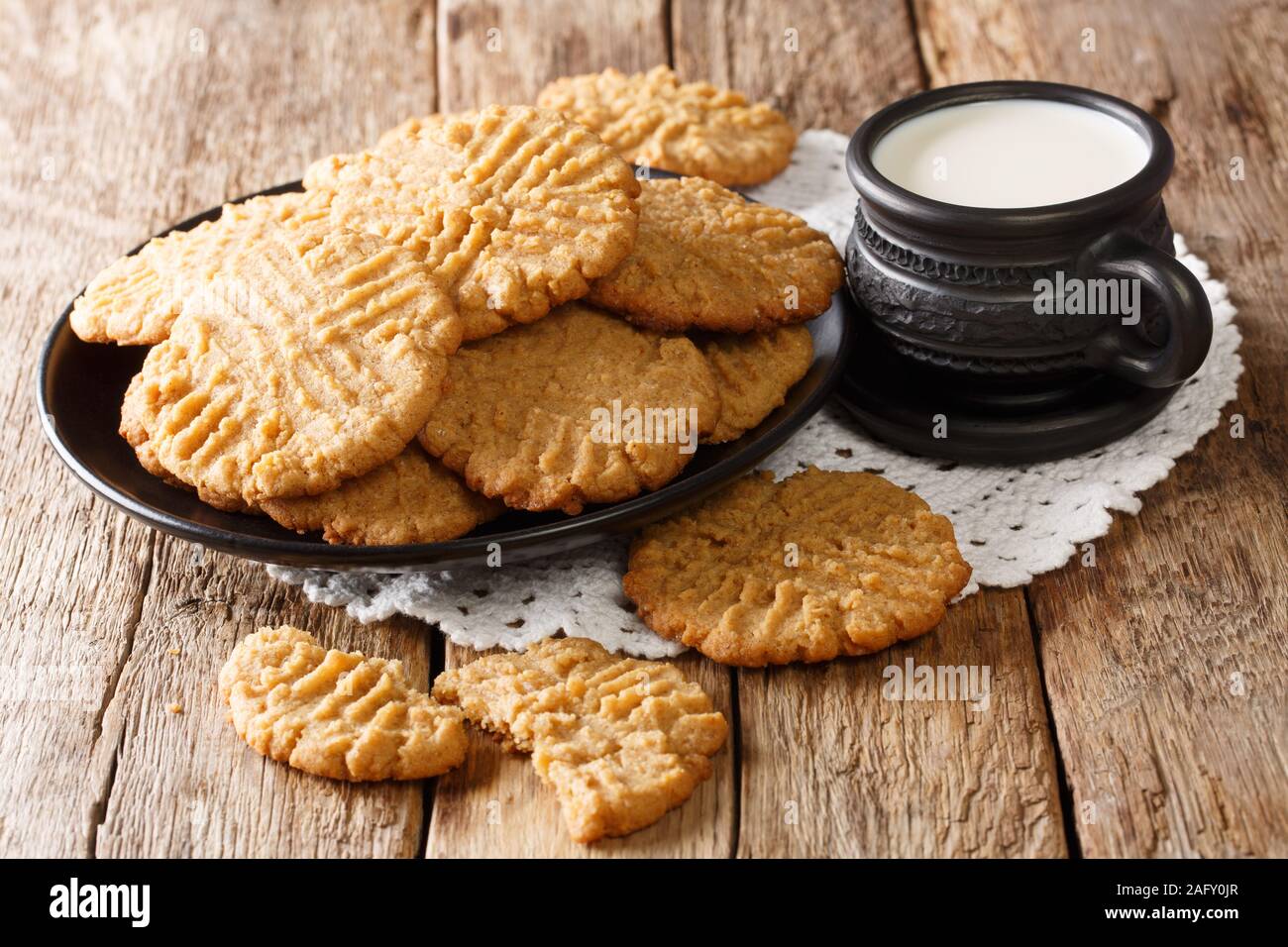 Peanut butter recipe cookies served with milk close-up on the table ...