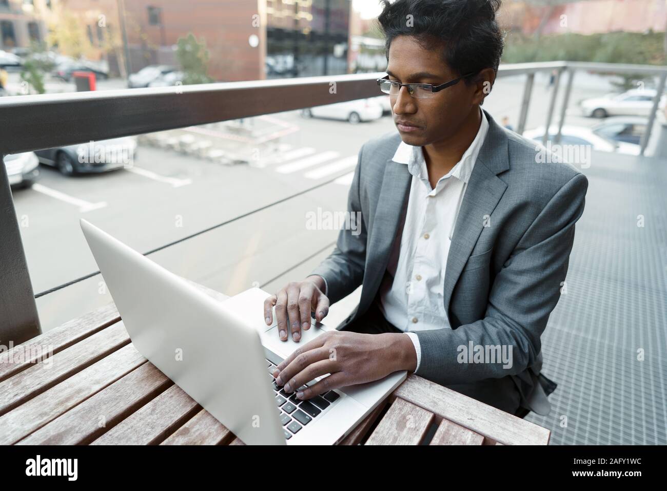 Young indian man sitting table hi-res stock photography and images - Alamy