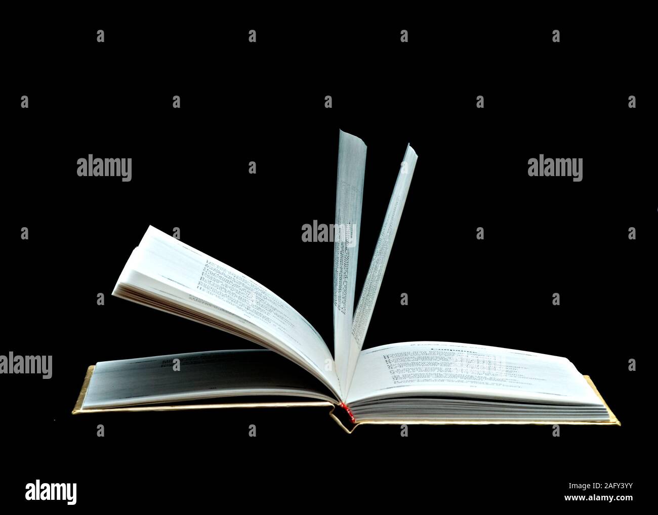 Open book isolated on black background Stock Photo - Alamy