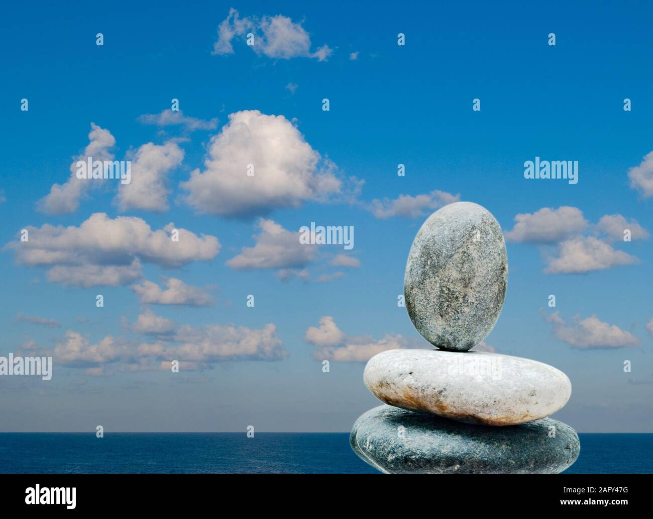 Three stones on seashore Stock Photo - Alamy