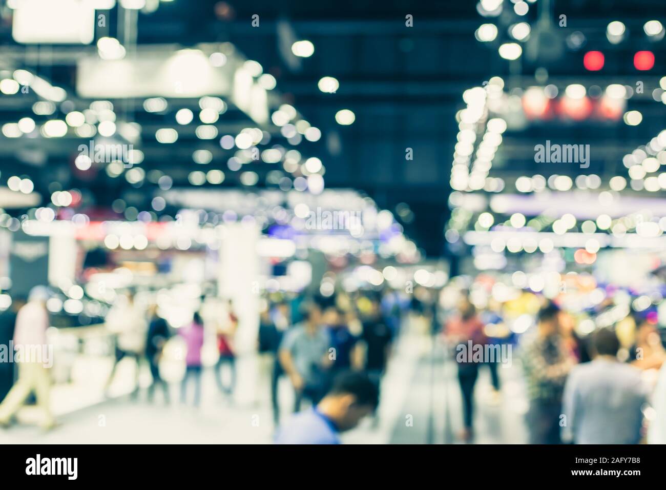 Blur event hall in large exhibition center with people walking ...