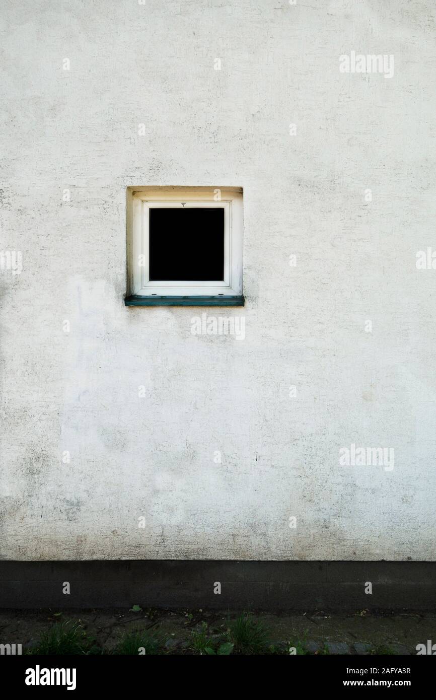 white wall and small square window Stock Photo - Alamy