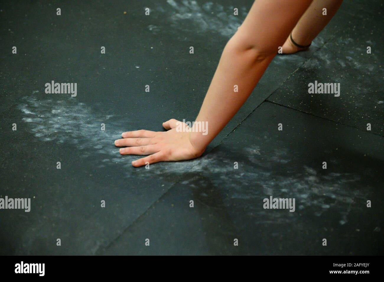 A woman's arms and hands on a chalked up floor during crossfit Stock ...