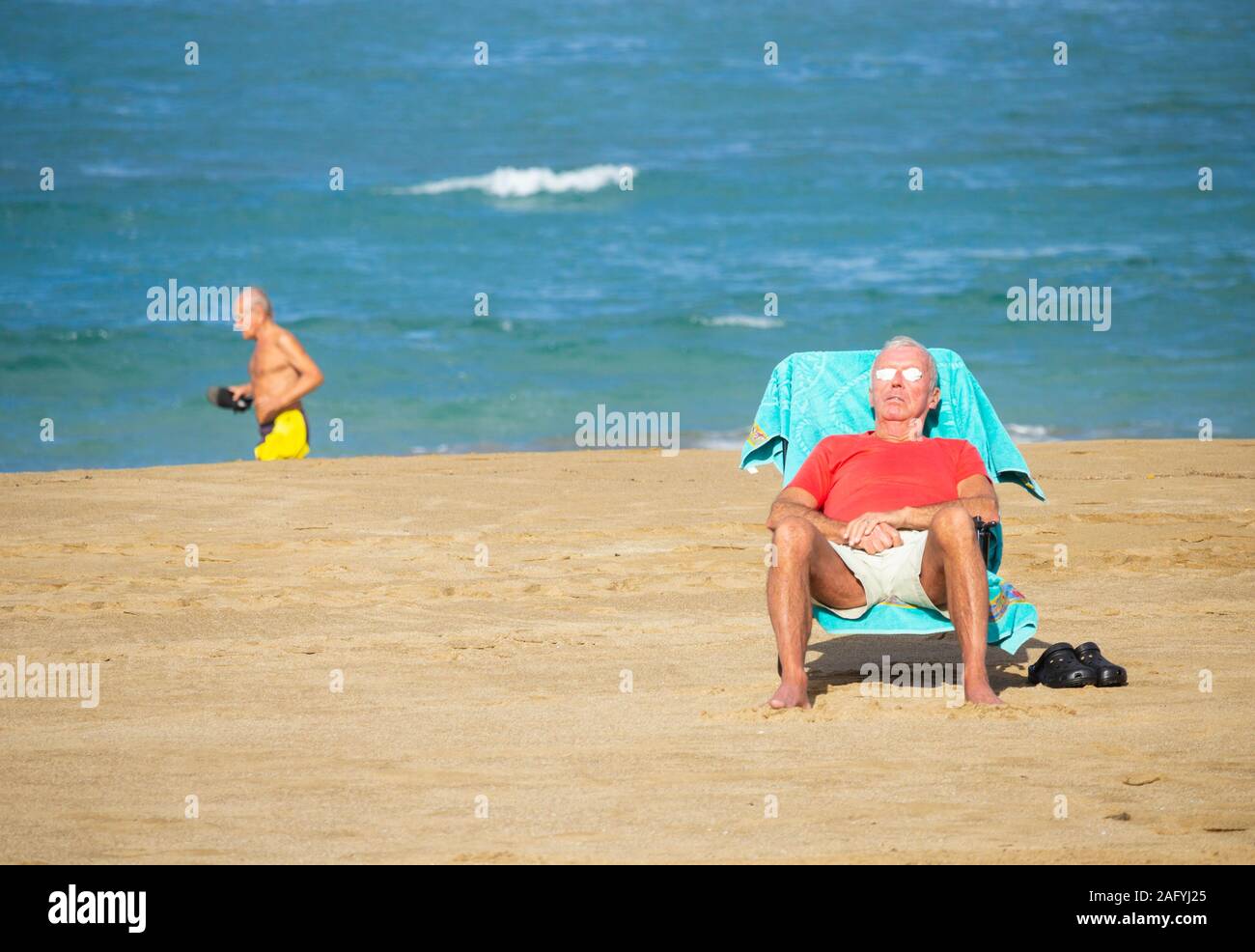 Old man sunbathing on beach hi-res stock photography and images - Alamy