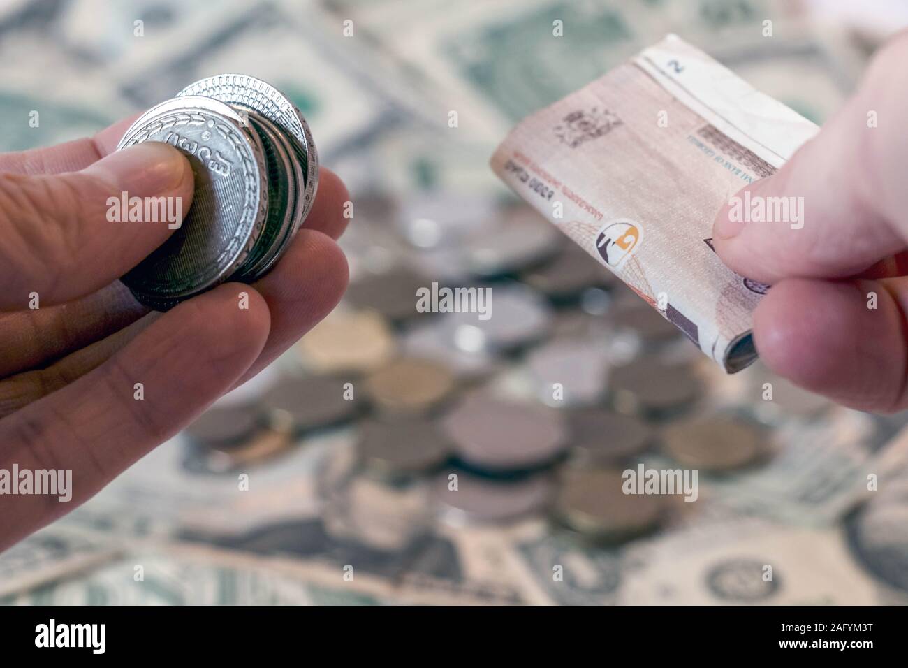 Hand holding georgian lari coins and banknotes against usd american ...