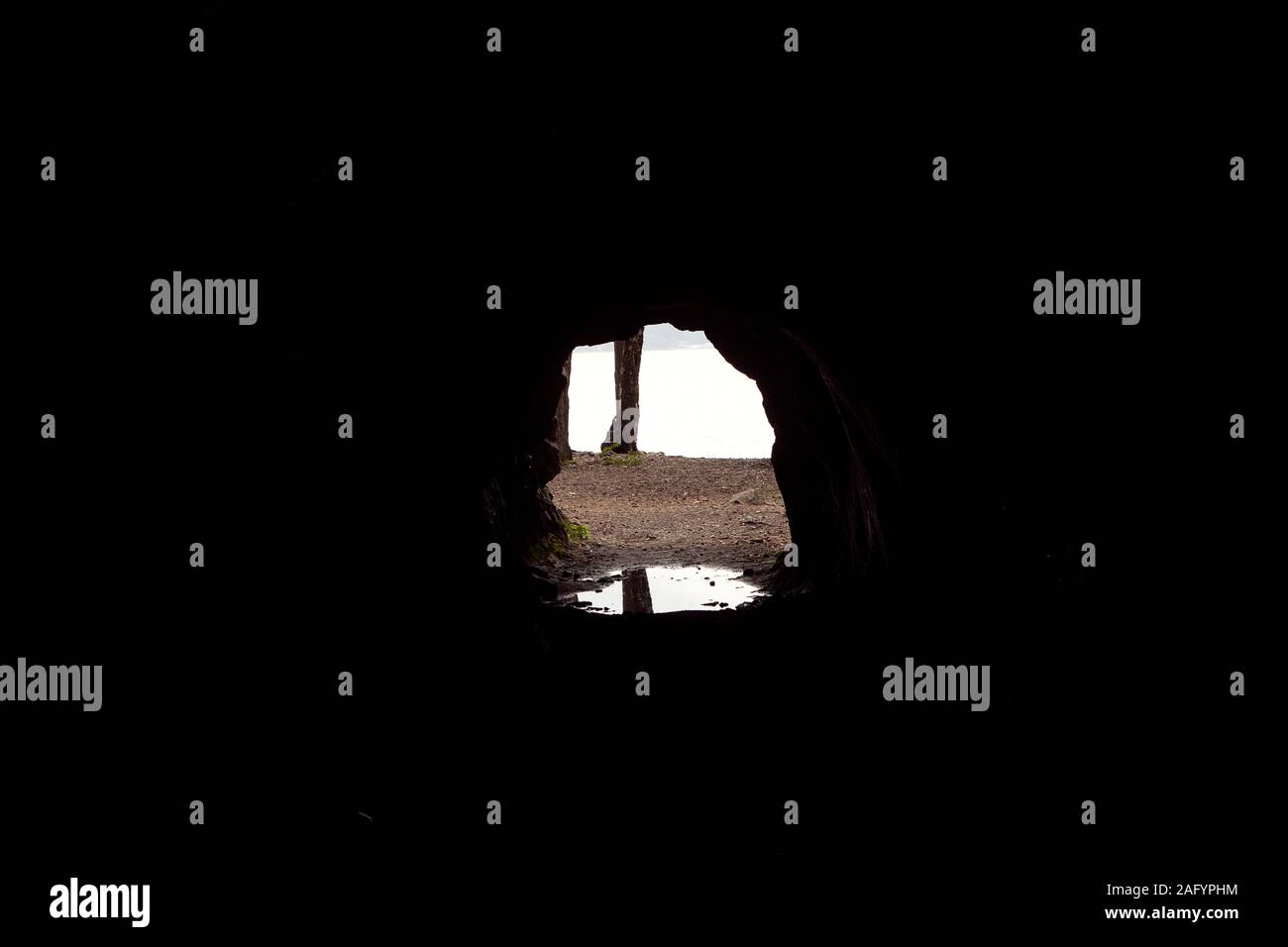 Mysterious Exit from a cave. Light at the end of the tunnel, visible ...