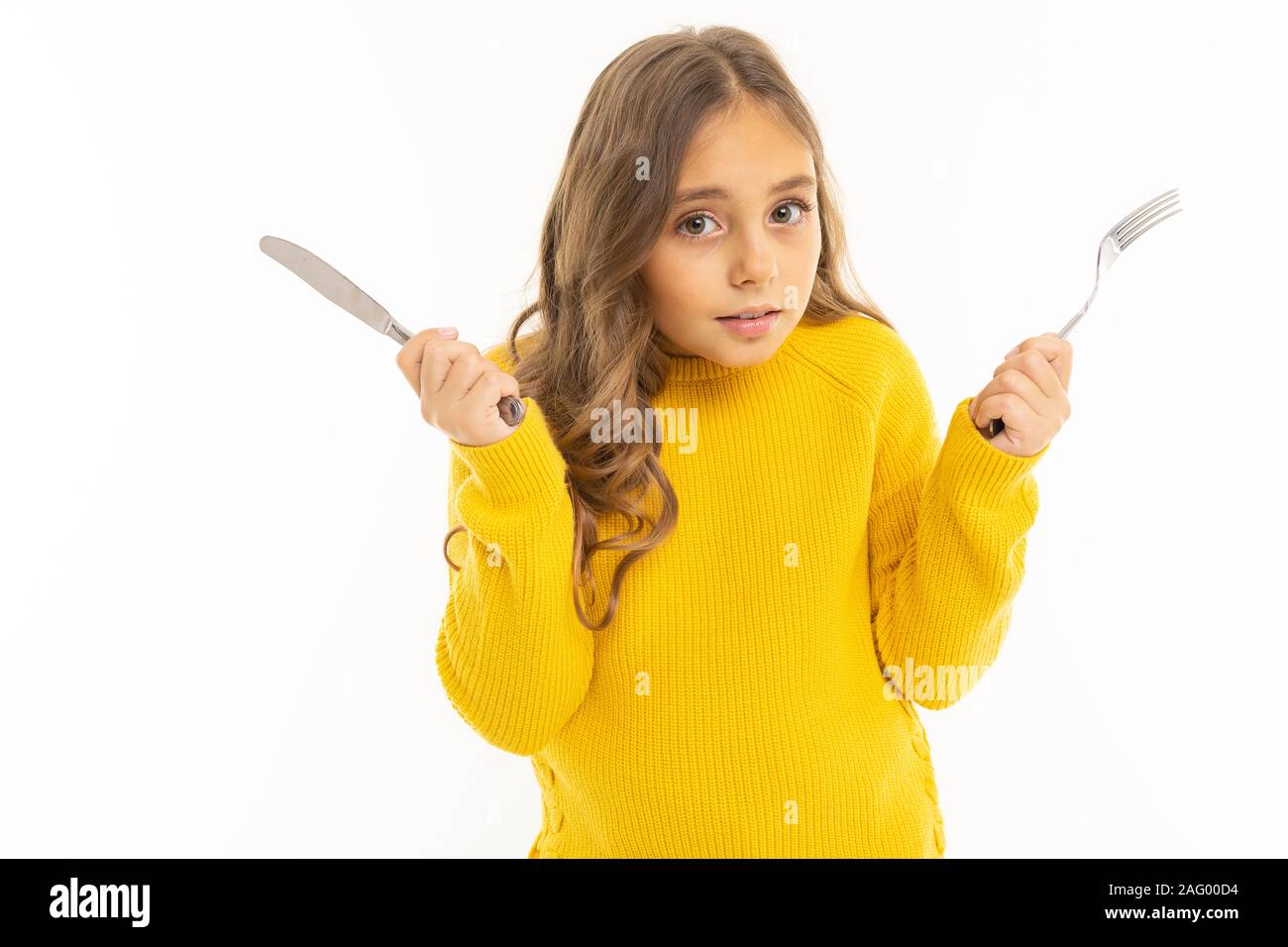 Girl holding up knife fork hi-res stock photography and images - Alamy