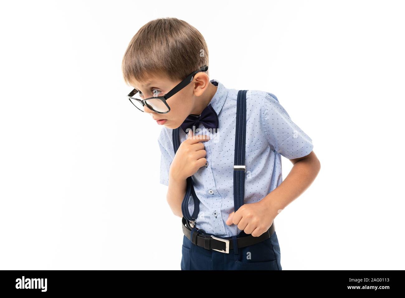 stylish educated boy in glasses and a classic suit proves something on ...