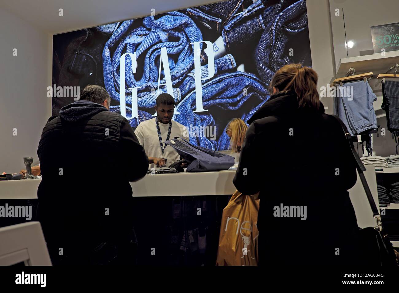 Customers people paying for purchases and young man working at checkout ...