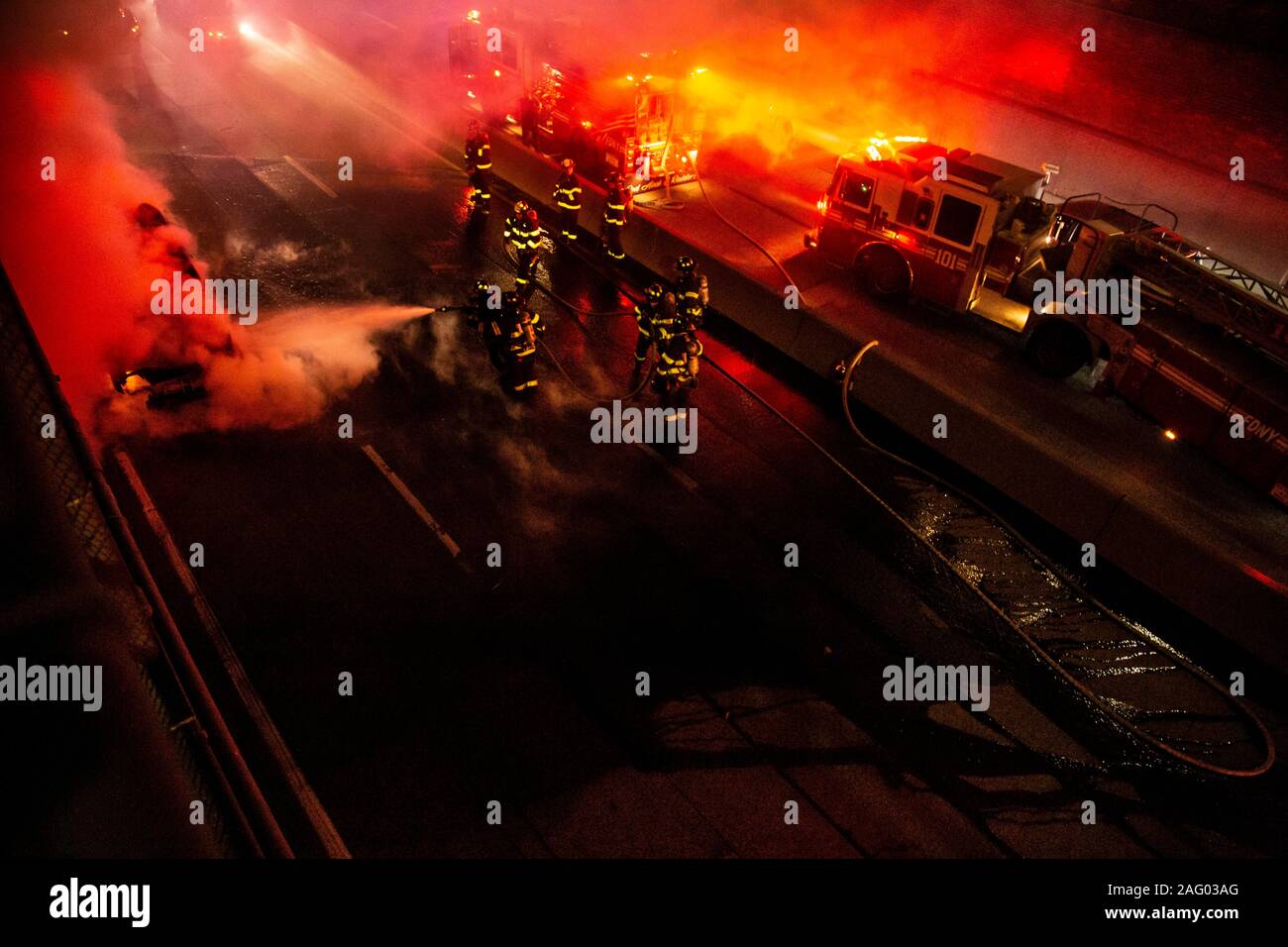 New York City Firefighters douse a car fare on Brooklyn, NY's Brooklyn ...