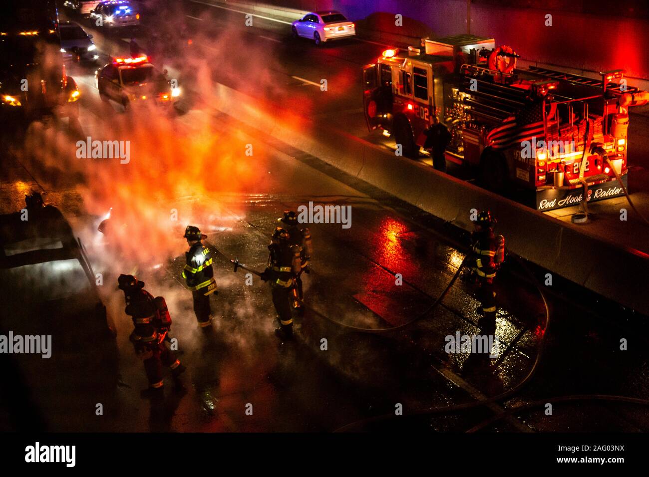 New York City Firefighters douse a car fare on Brooklyn, NY's Brooklyn ...