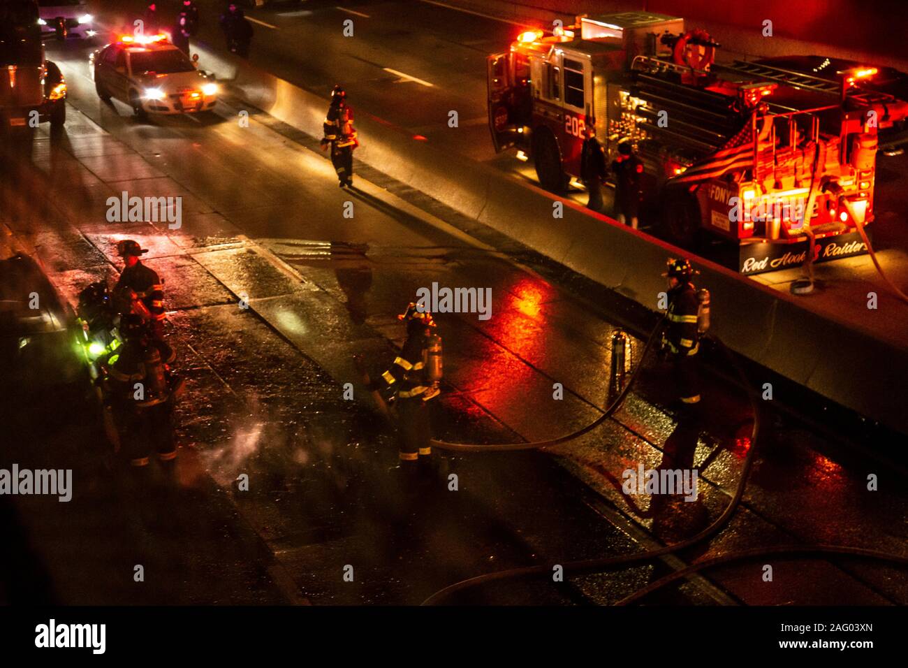 New York City Firefighters douse a car fare on Brooklyn, NY's Brooklyn ...