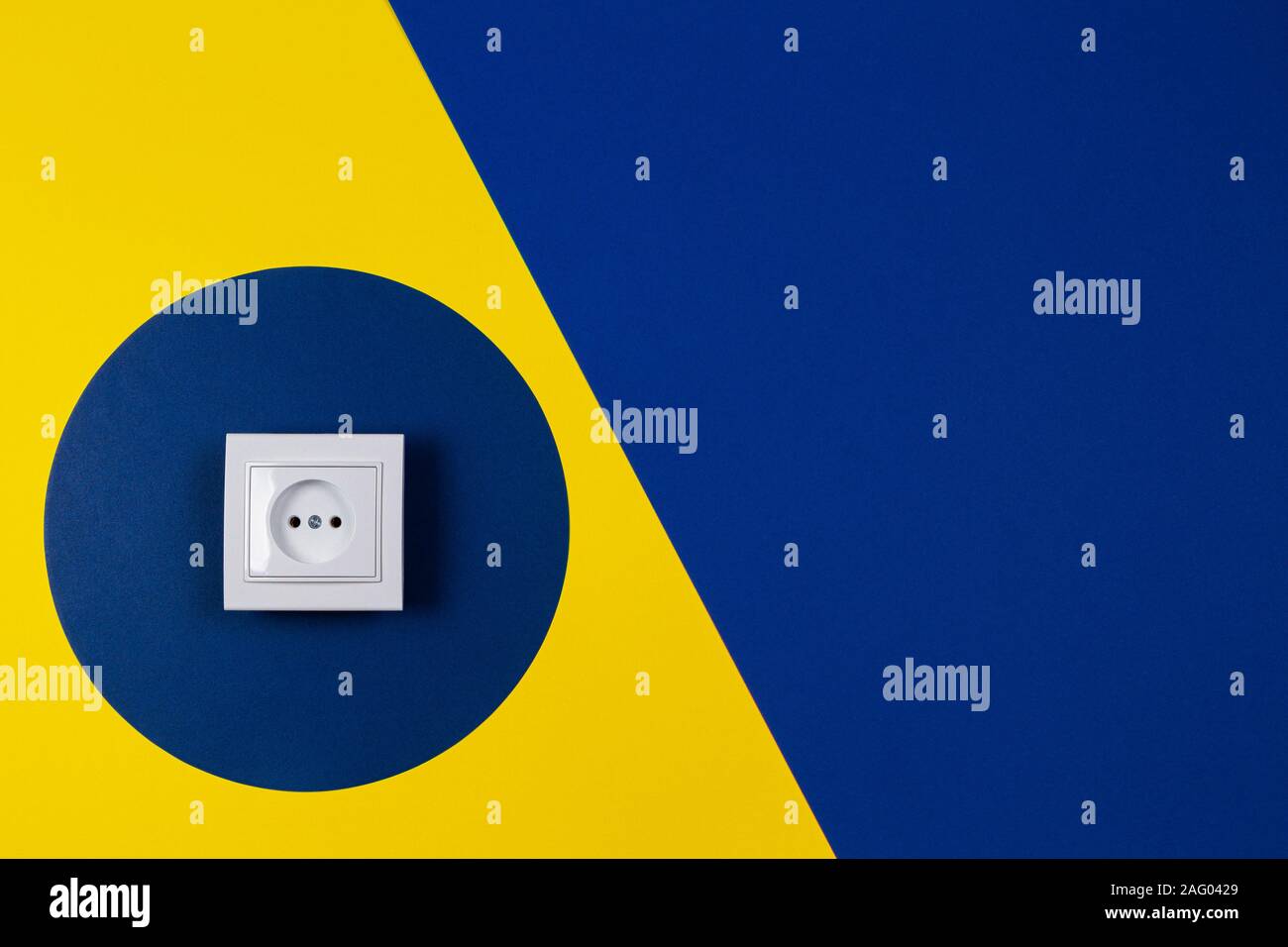 White electrical socket on geometric yellow and blue navy color ...