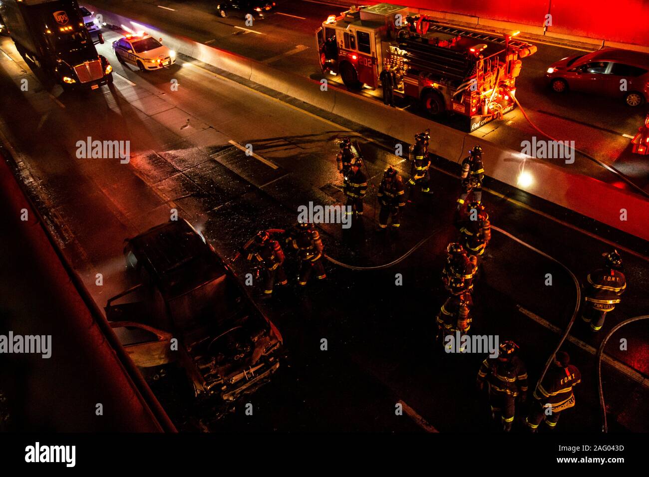 New York City Firefighters douse a car fare on Brooklyn, NY's Brooklyn ...