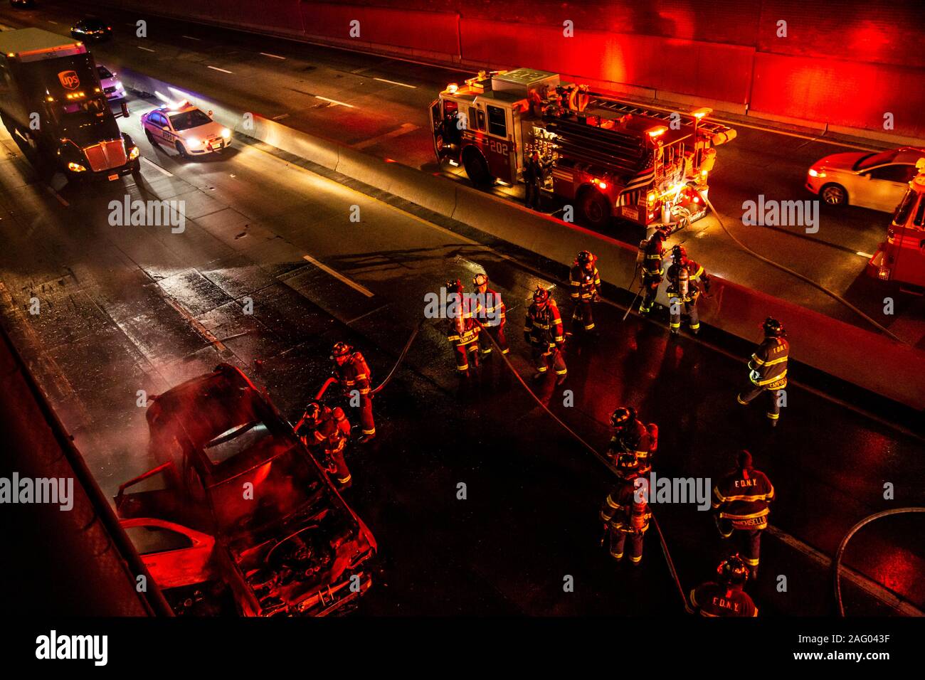 New York City Firefighters douse a car fare on Brooklyn, NY's Brooklyn ...