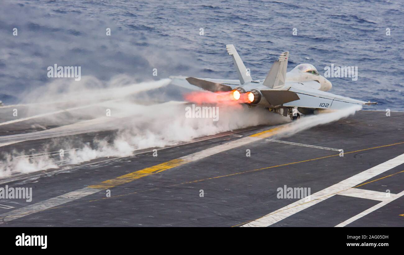 A U.S. Navy F/A-18F Super Hornet fighter aircraft attached to the Black ...