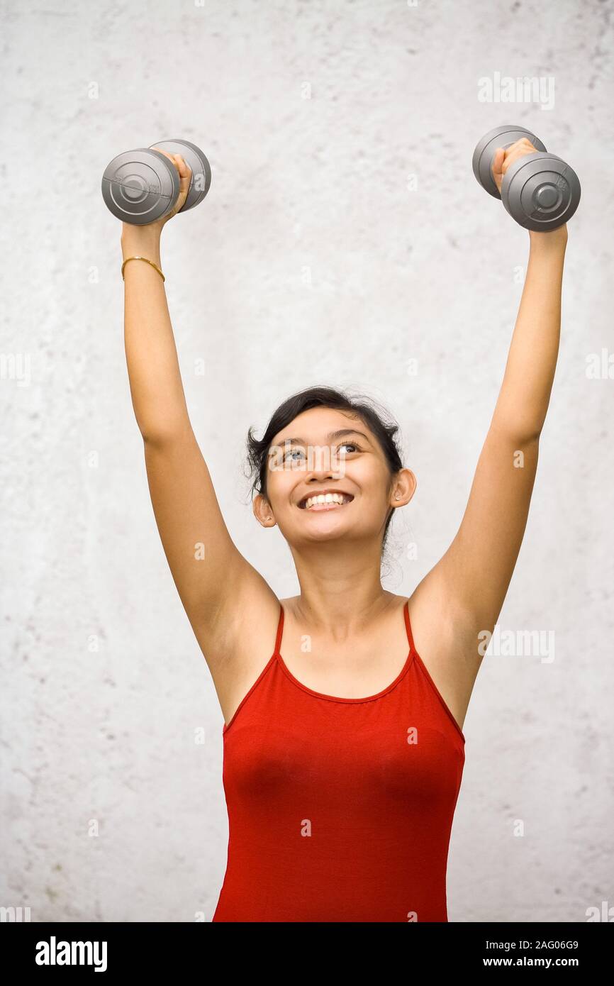 Portrait of happy, healthy and strong Southeast Asian young woman in ...