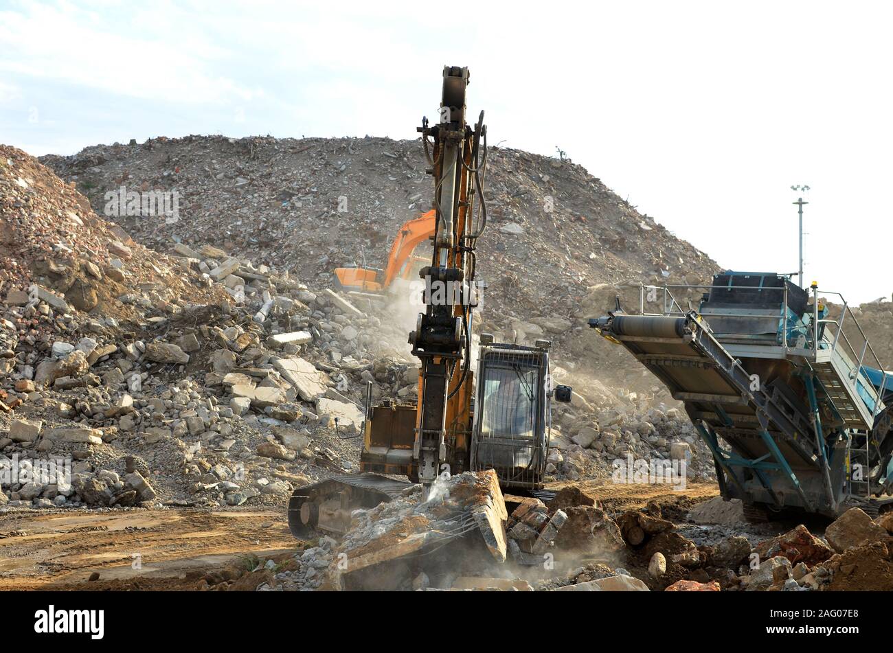 Salvaging and recycling building and construction materials. Excavator ...