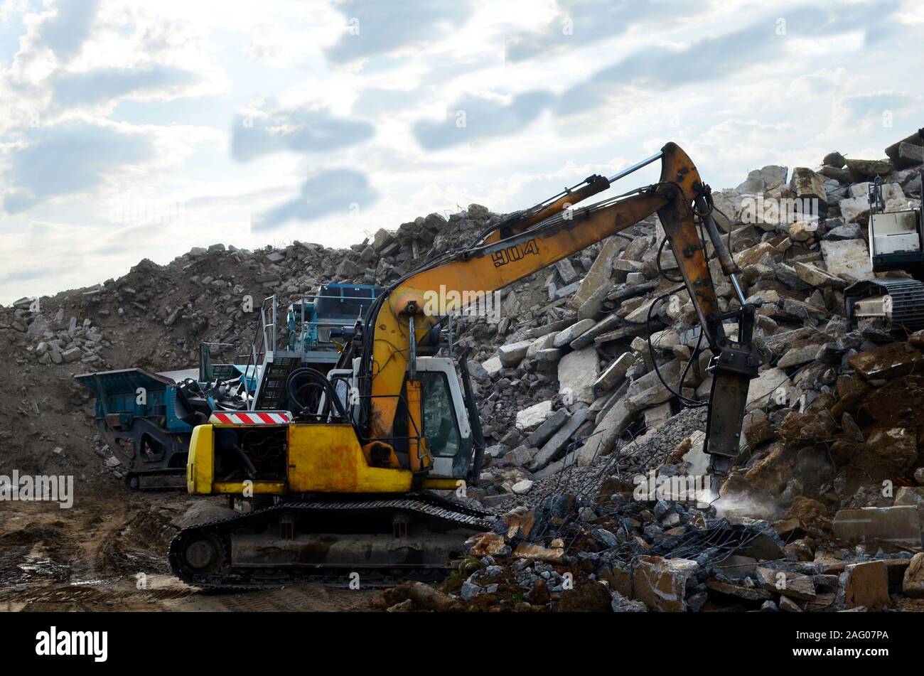Salvaging and recycling building and construction materials. Excavator ...