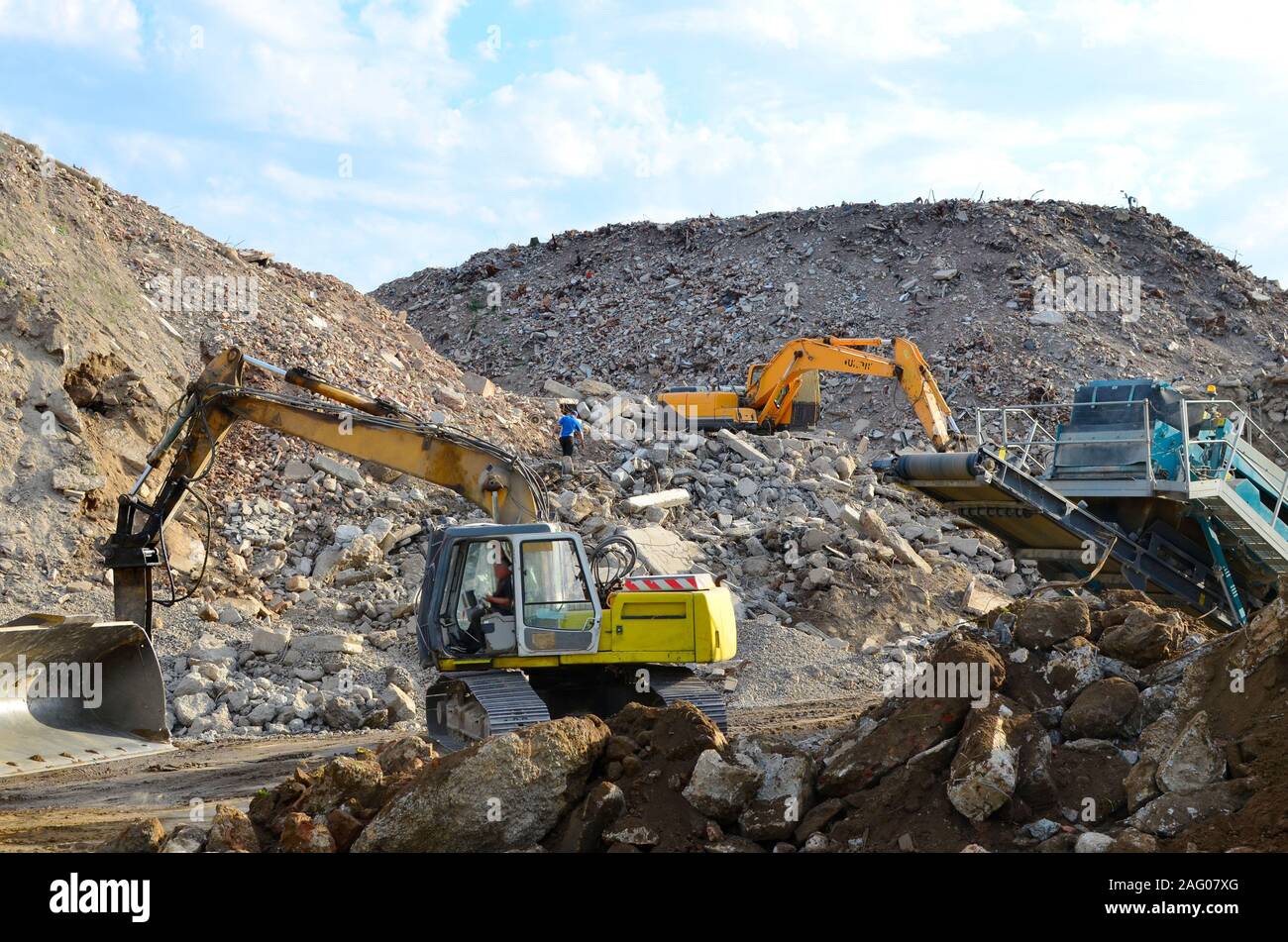 Salvaging and recycling building and construction materials. Excavator ...