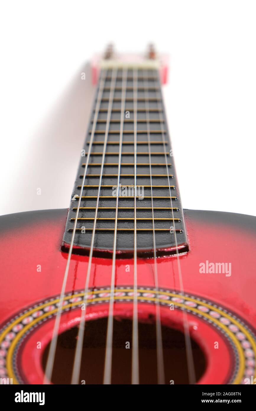 Red six-string guitar on a white background Stock Photo - Alamy