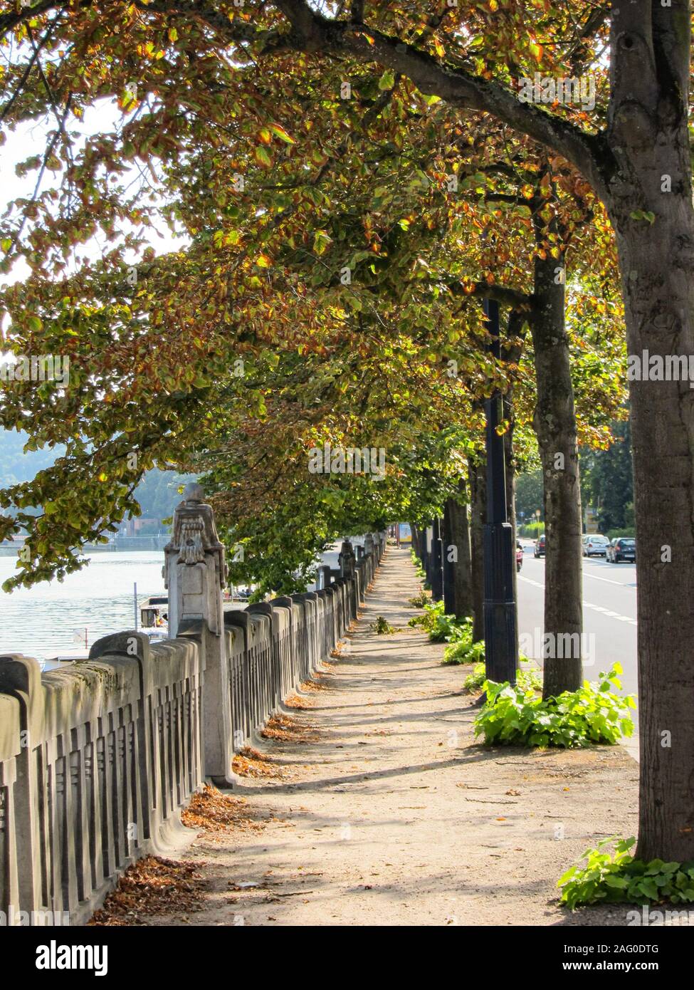 Stone riverfront with autumn trees in the city Stock Photo - Alamy