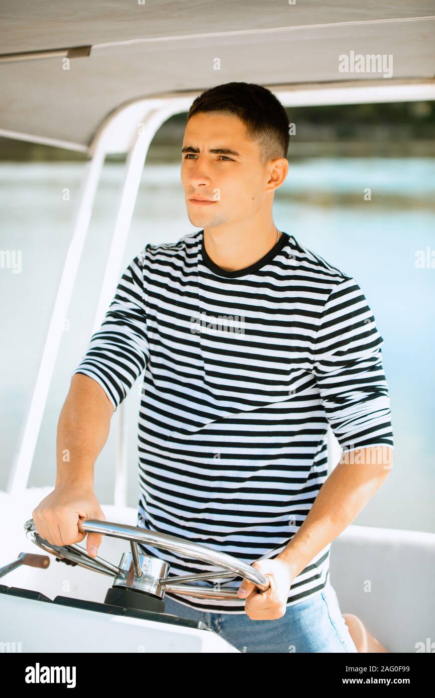 Sailor at the steering wheel of a sailing ship hi-res stock photography ...