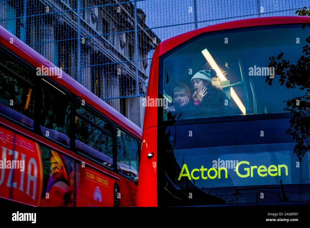 kids looking out top window of double decker bus, London, England, UK ...