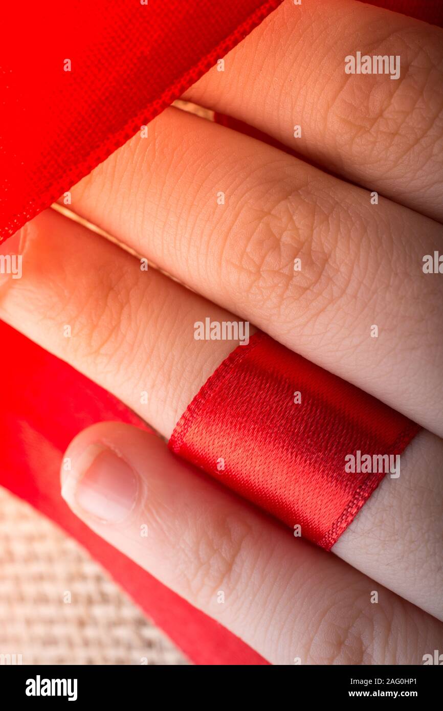 Red string tied around ring finger of the hand Stock Photo - Alamy